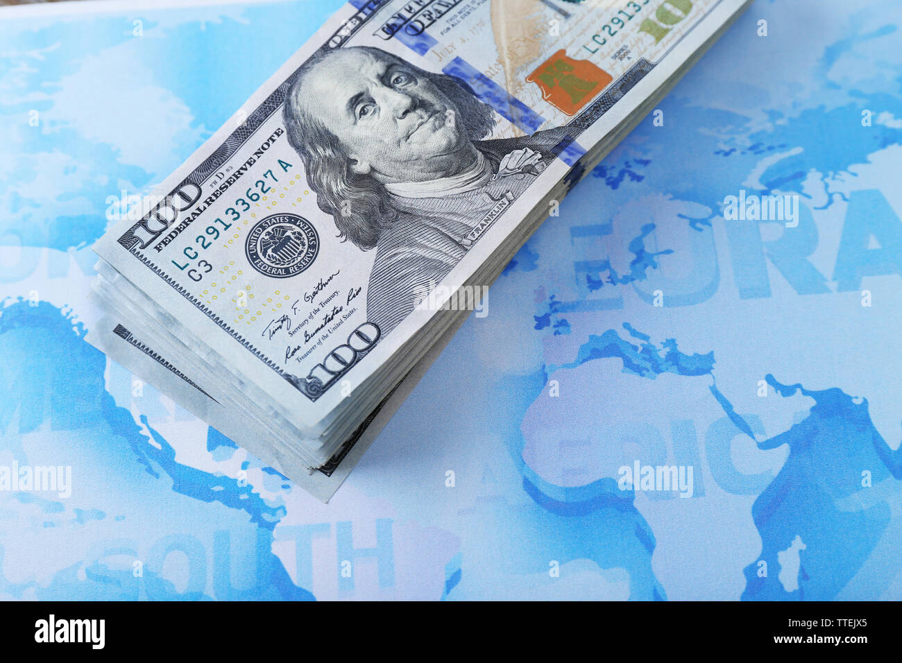 Cash on the world map background, close up Stock Photo - Alamy