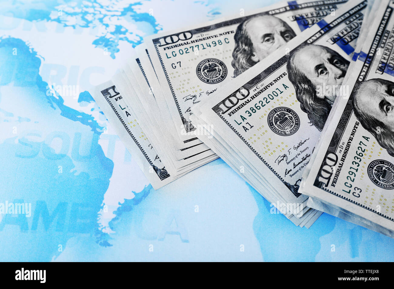 Cash on the world map background, close up Stock Photo - Alamy