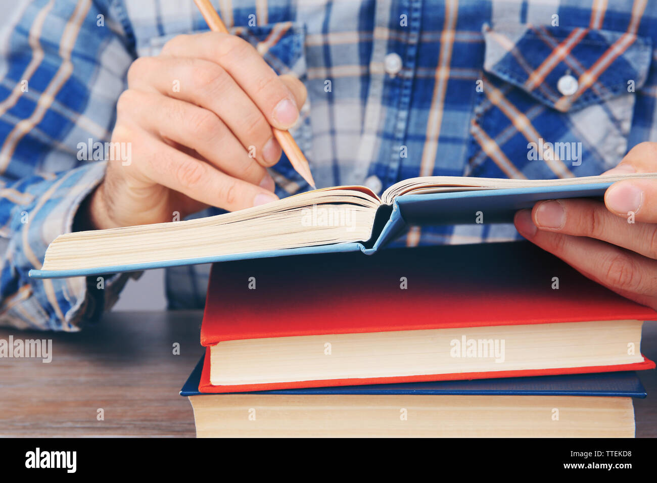 Man working with books, close up Stock Photo - Alamy