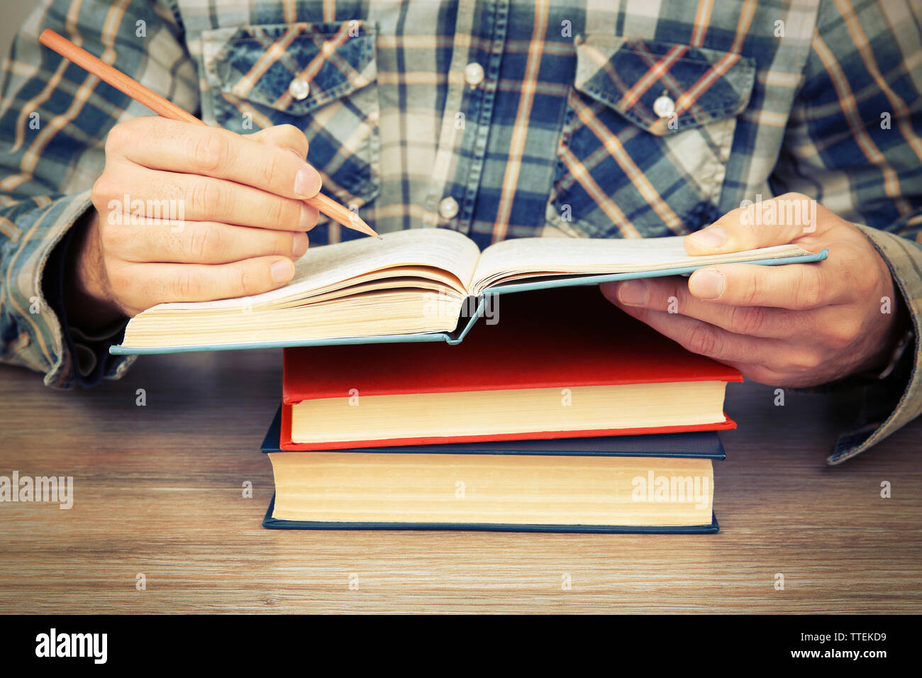 Man working with books, close up Stock Photo - Alamy