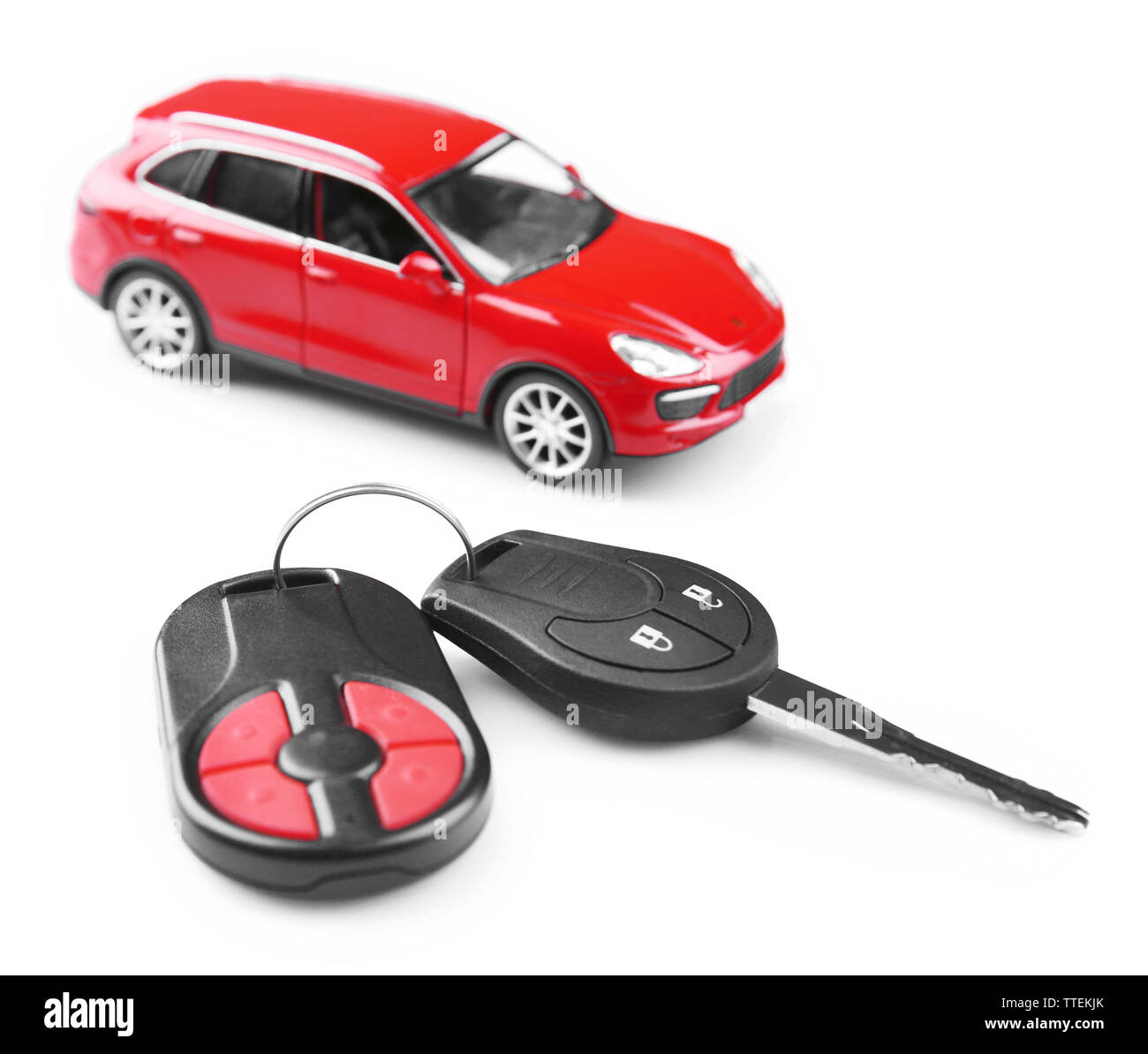 Little red car with key isolated on white background Stock Photo - Alamy