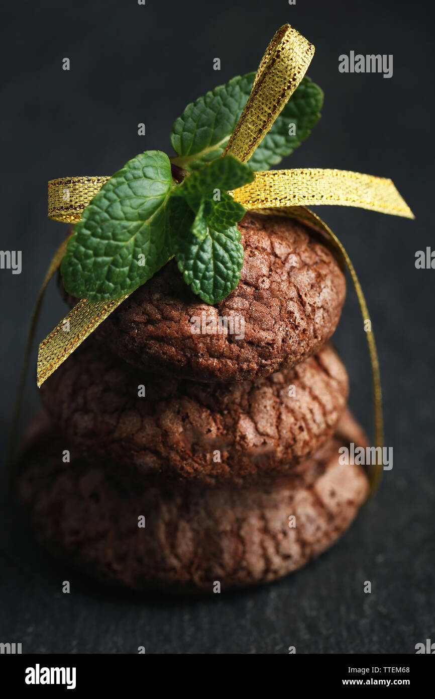 Chocolate chip cookie with yellow stripe and mint on dark background ...
