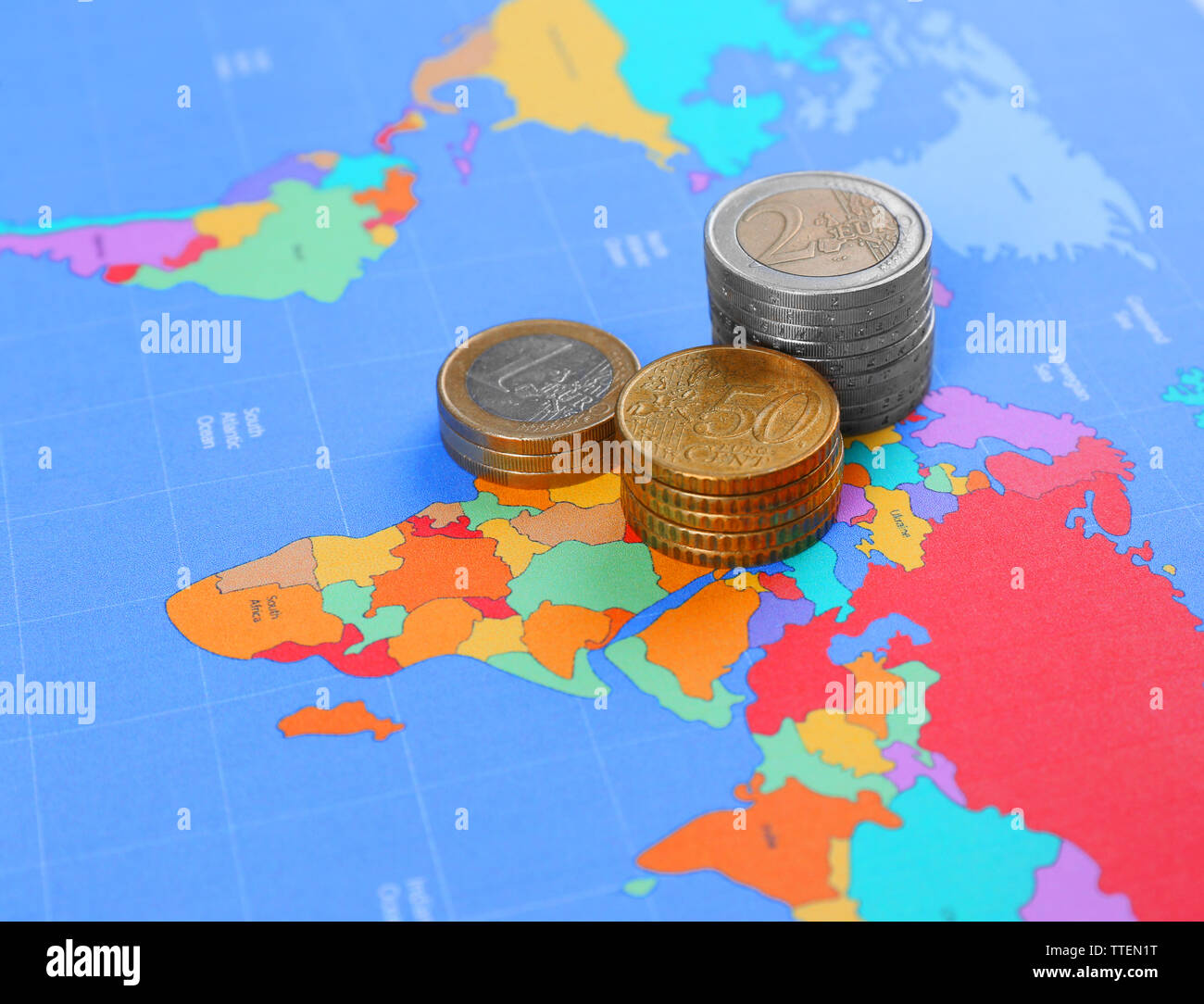 Euro coins on map background Stock Photo - Alamy