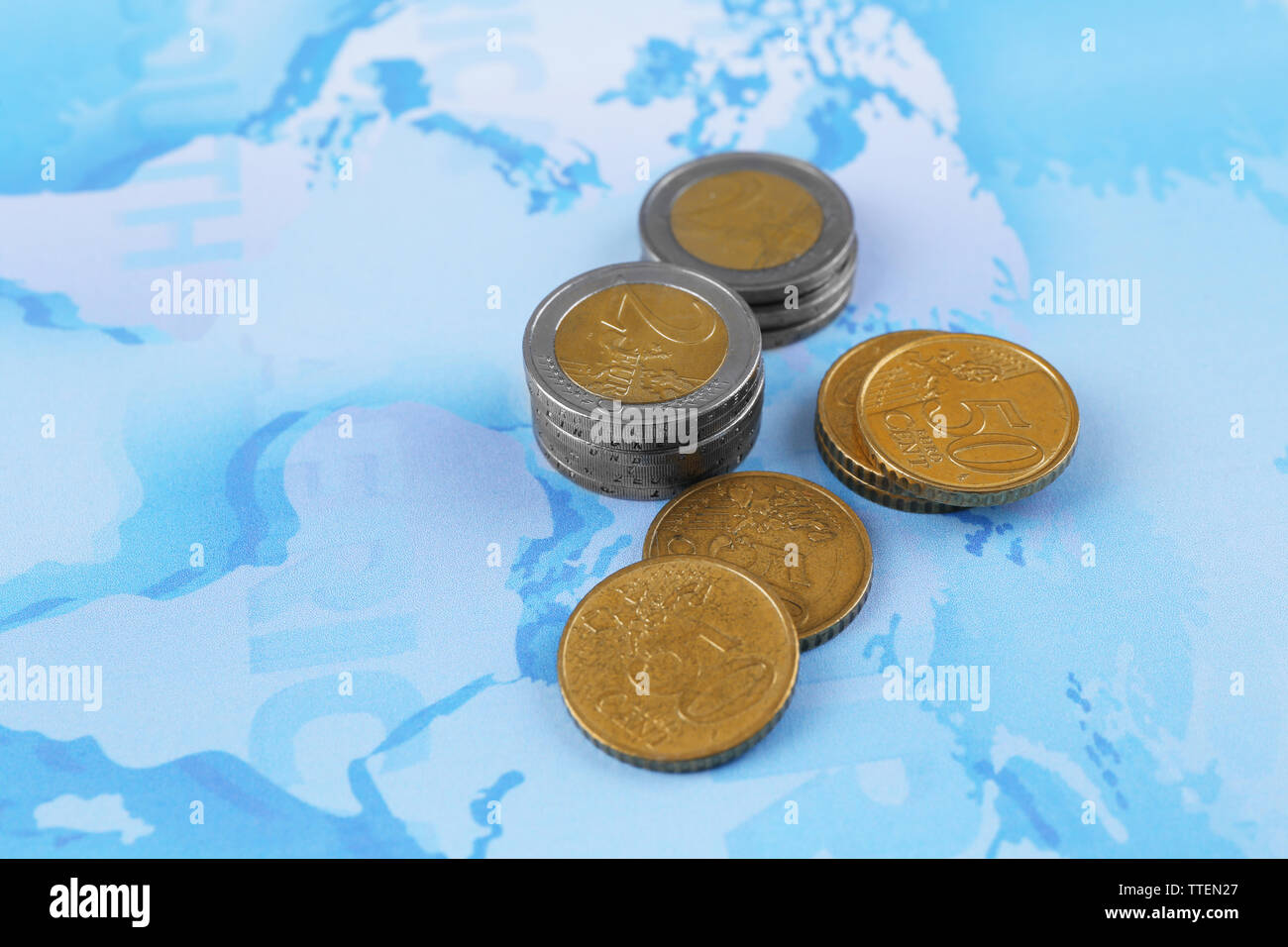 Euro coins on map background Stock Photo - Alamy