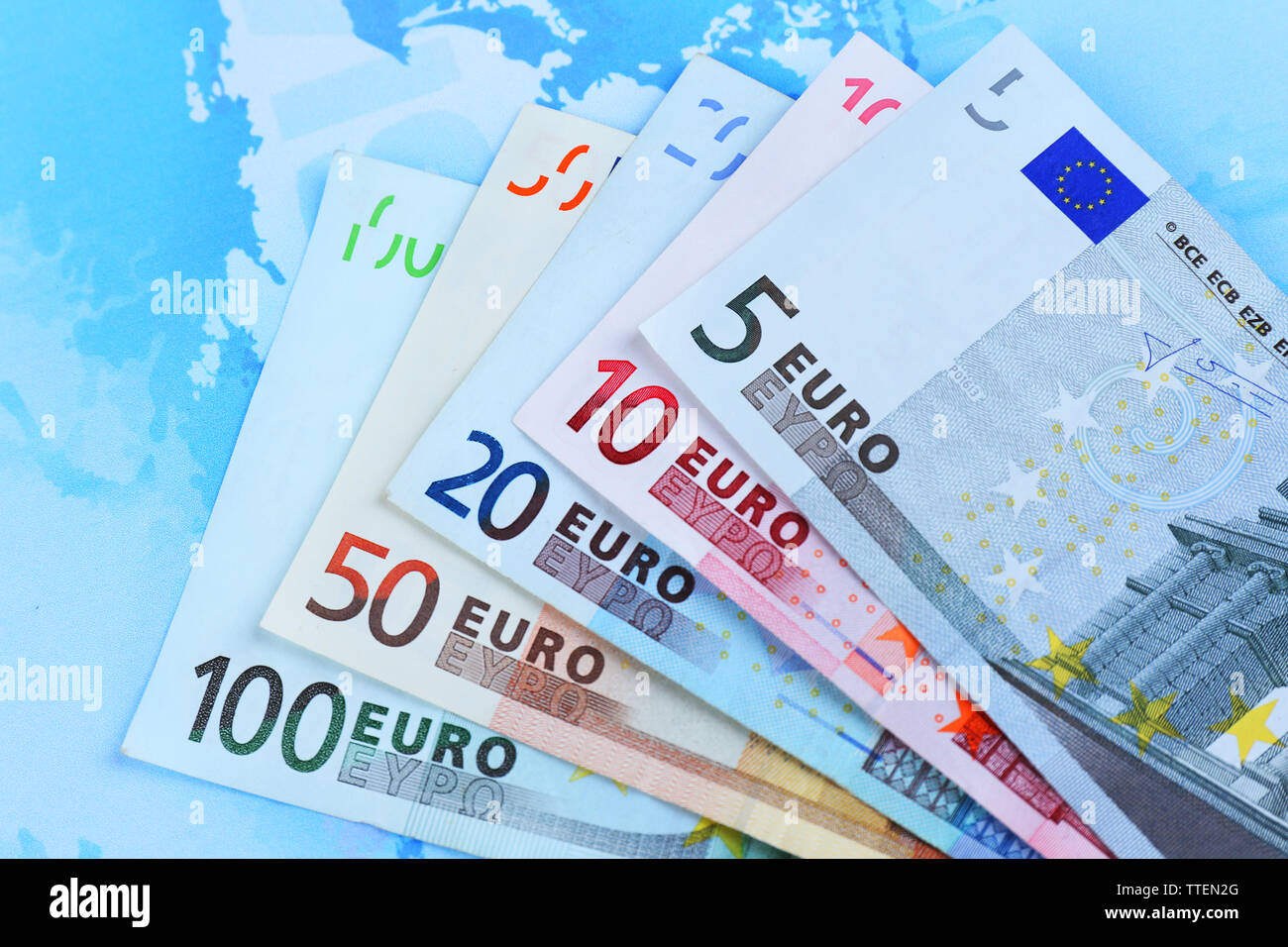 Different euro banknotes on a map background Stock Photo - Alamy