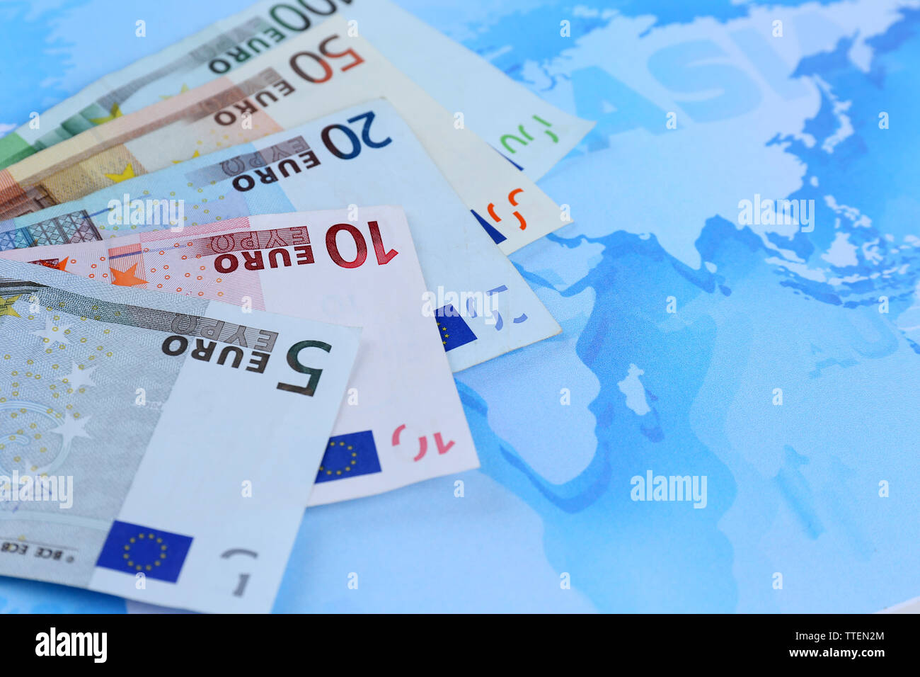 Different euro banknotes on a map background Stock Photo - Alamy