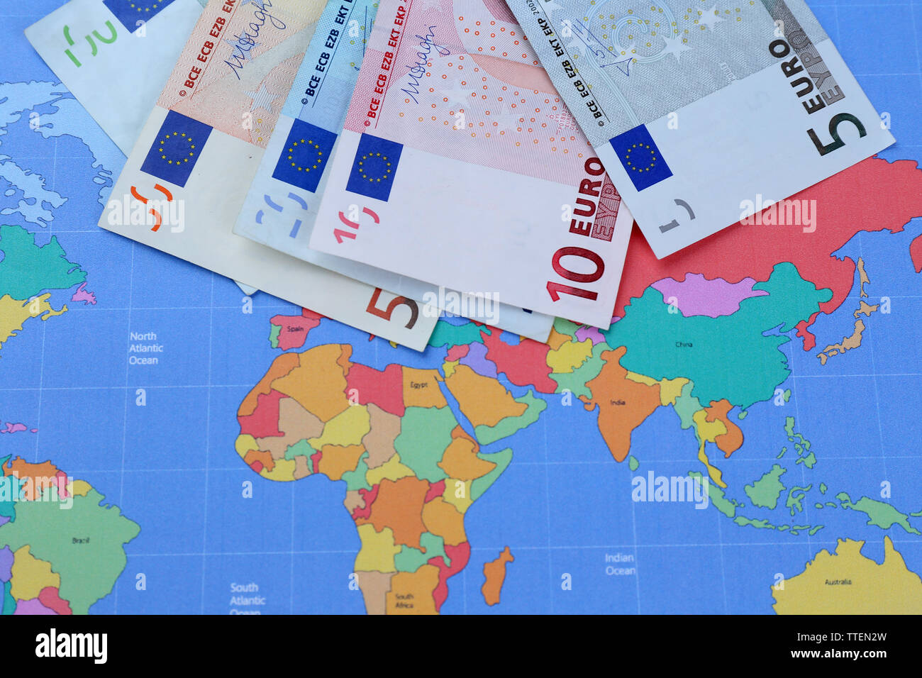 Different euro banknotes on a map background Stock Photo - Alamy