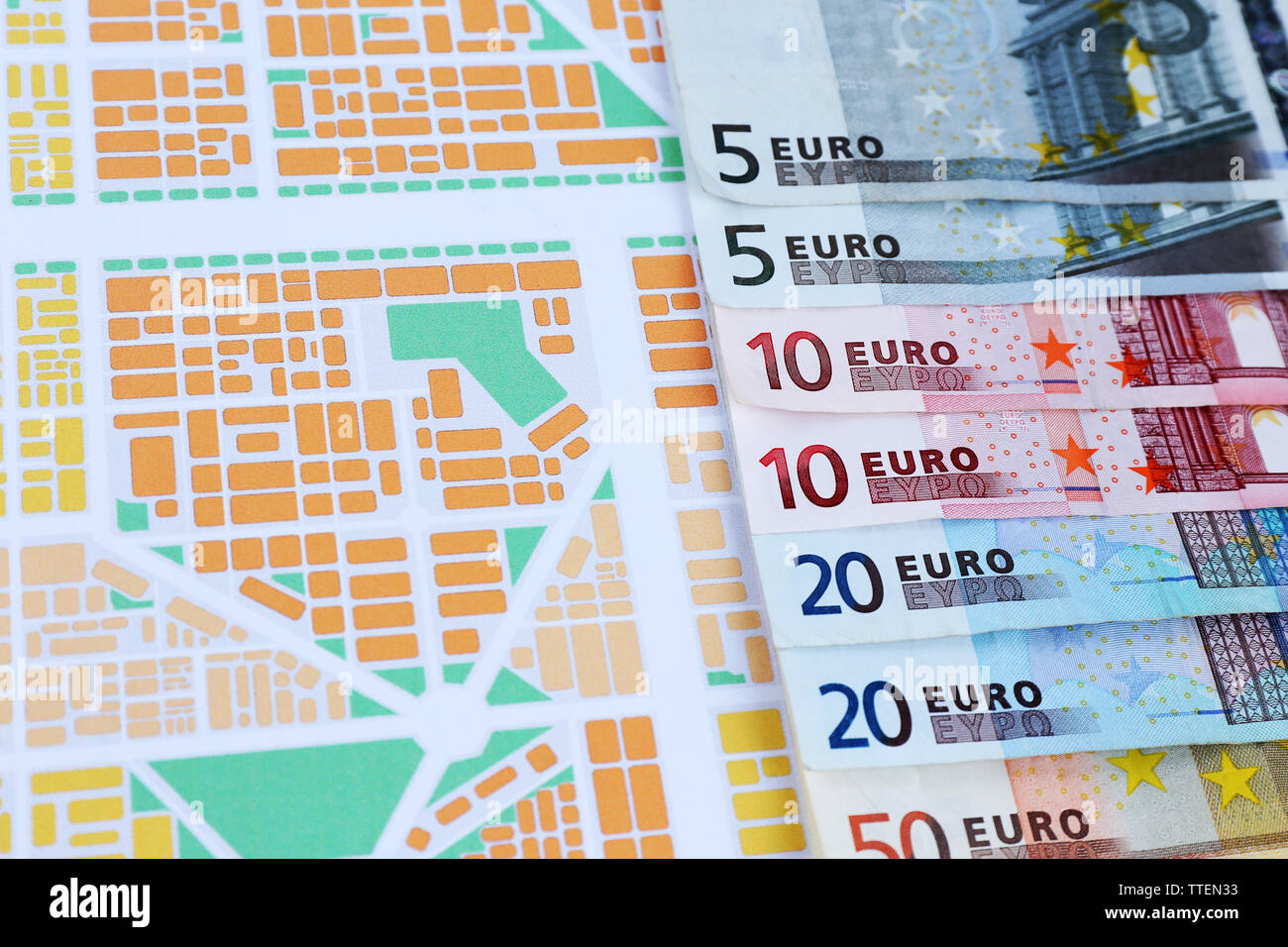 Different euro banknotes on a map background Stock Photo - Alamy