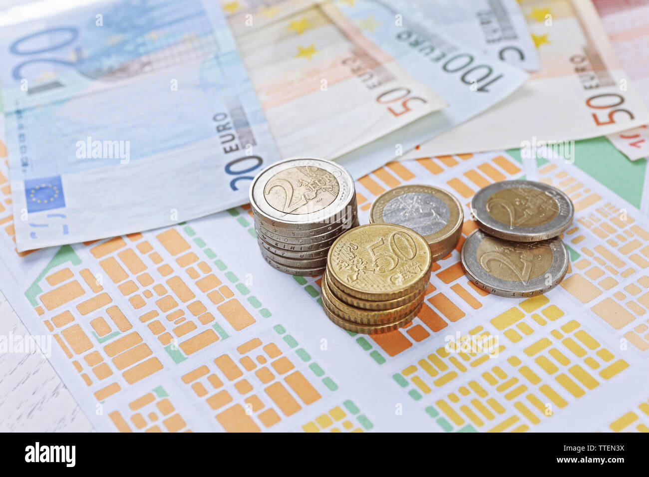 Euro coins and banknotes on map background Stock Photo - Alamy