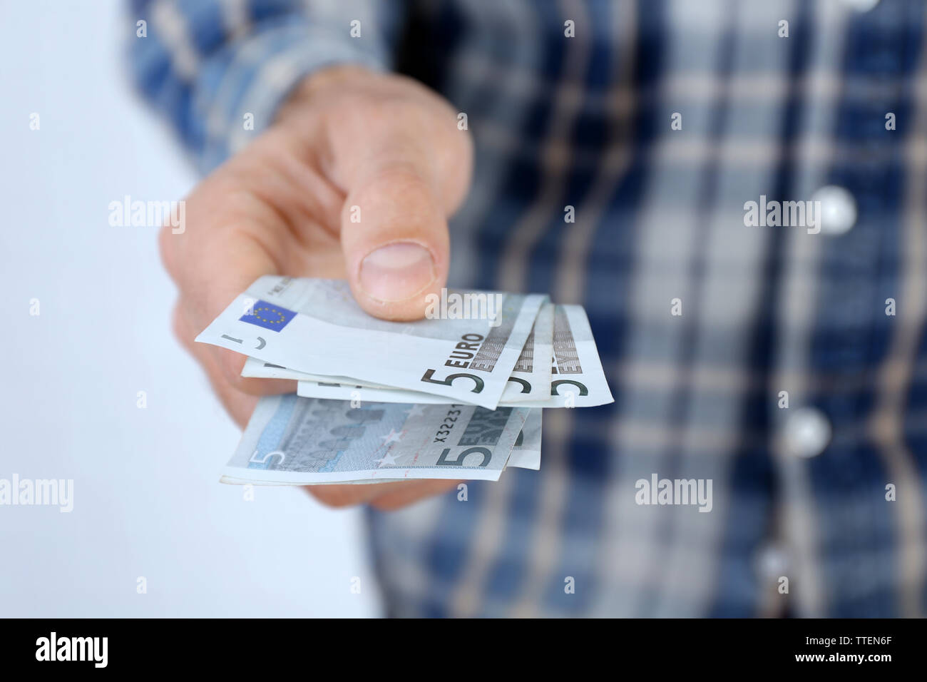 Man holding euros in hand Stock Photo - Alamy