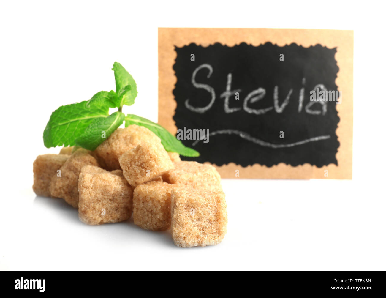 Pile of brown sugar cubes and stevia isolated on white background Stock ...
