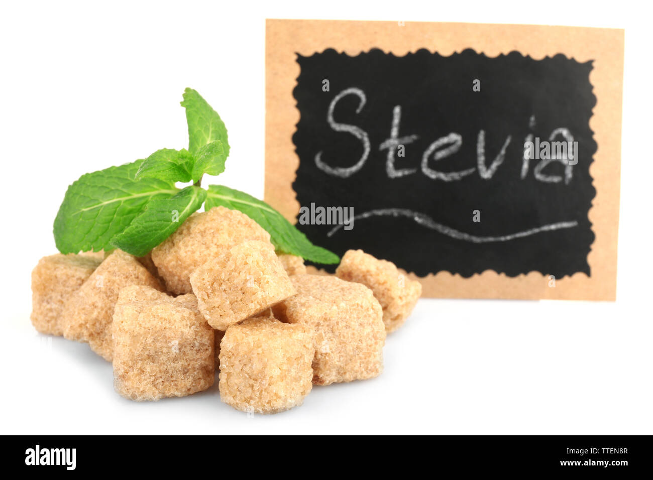 Pile of brown sugar cubes and stevia isolated on white background Stock ...