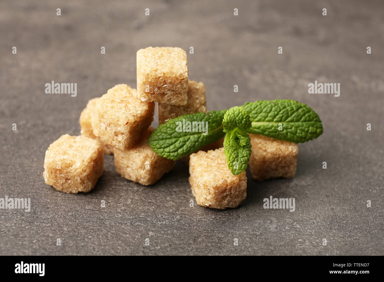 Pile of brown sugar cubes and stevia on the table, close up Stock Photo ...