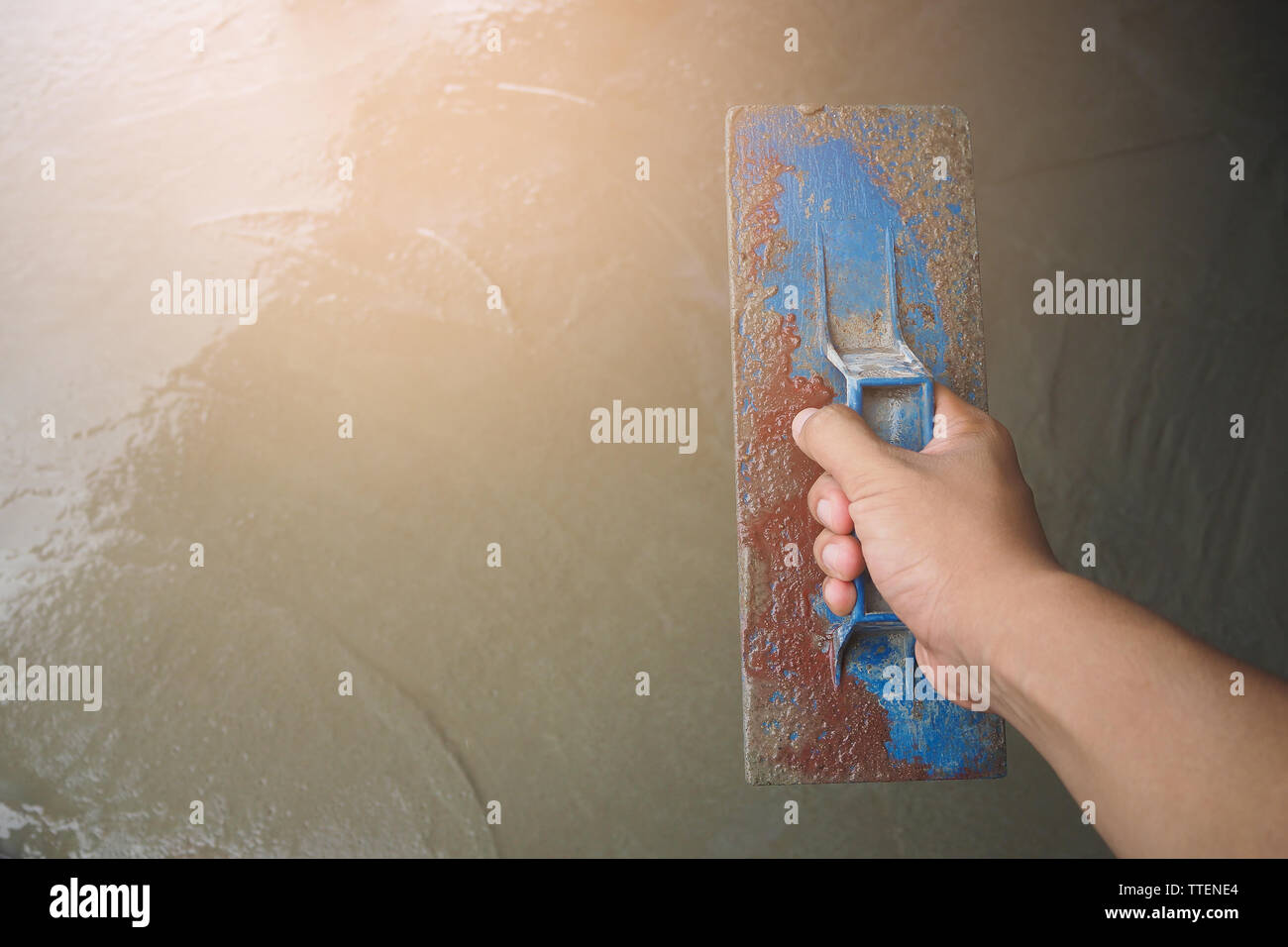 Hand holding plastic shovel for cement work construction Stock Photo ...