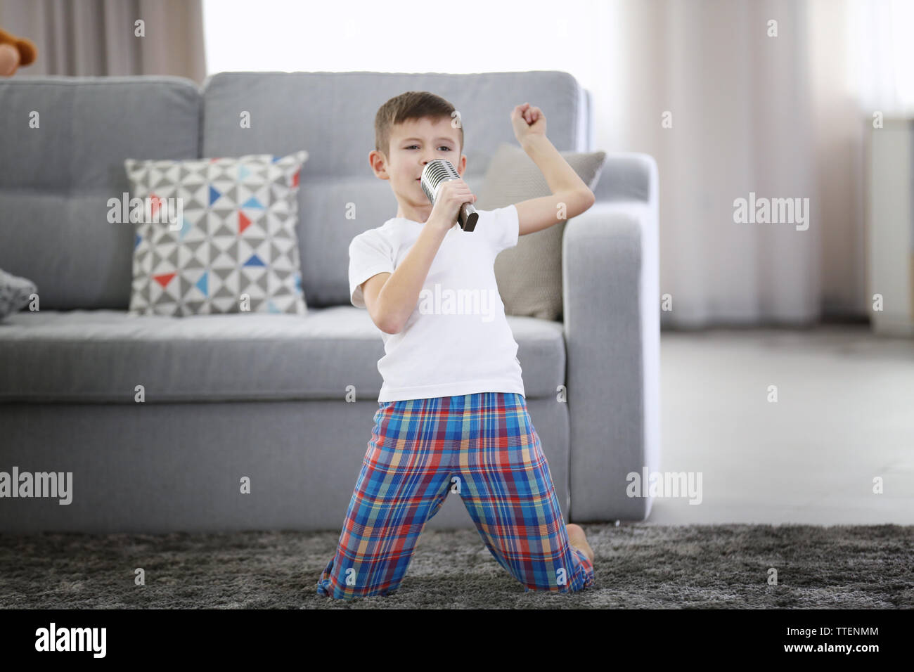 Little boy singing with a microphone at home Stock Photo - Alamy