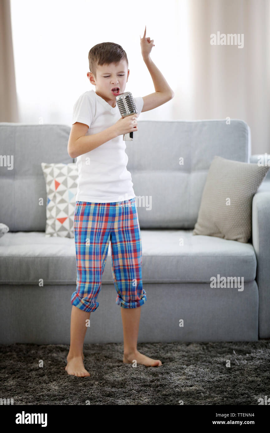 Little boy singing with a microphone at home Stock Photo - Alamy
