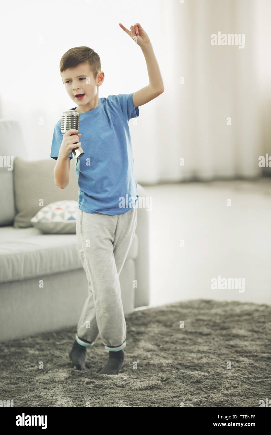 Little boy singing with microphone at home Stock Photo - Alamy