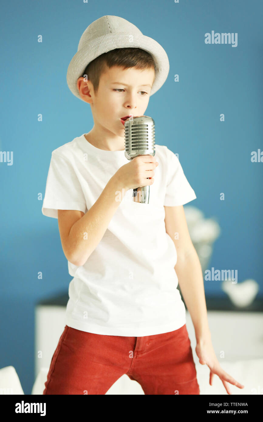 Little boy singing with microphone on a sofa at home Stock Photo - Alamy