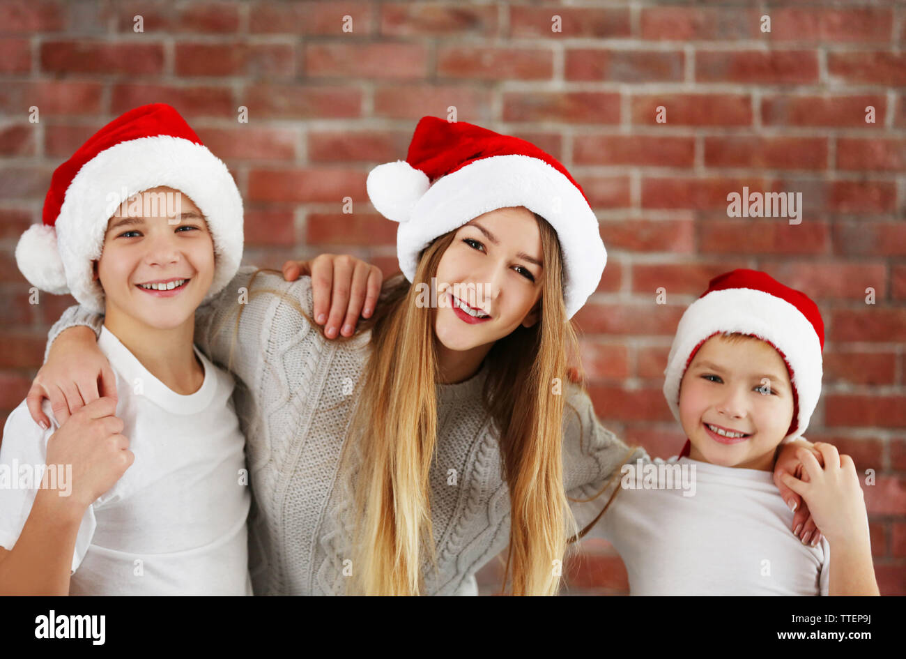 Happy cousins on brick wall background Stock Photo - Alamy