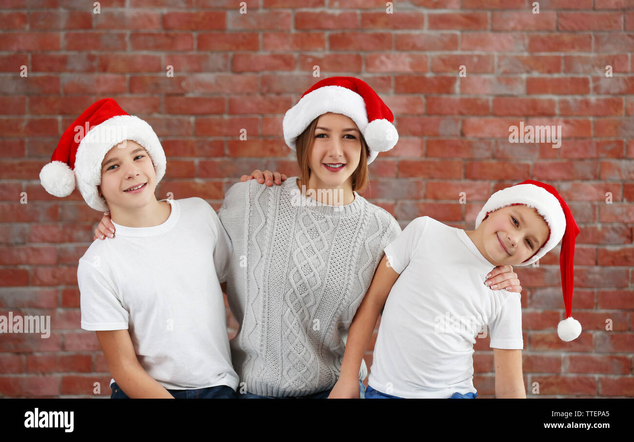 Happy cousins on brick wall background Stock Photo - Alamy