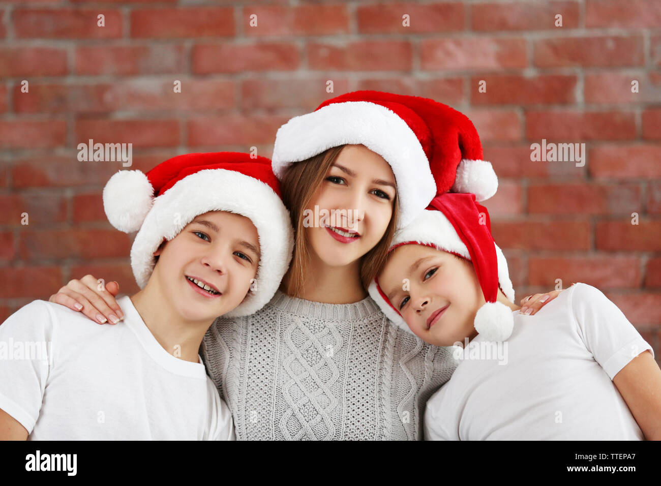 Happy cousins on brick wall background Stock Photo - Alamy