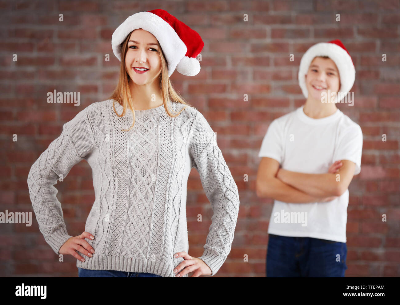 Happy cousins have fun on brick wall background Stock Photo - Alamy