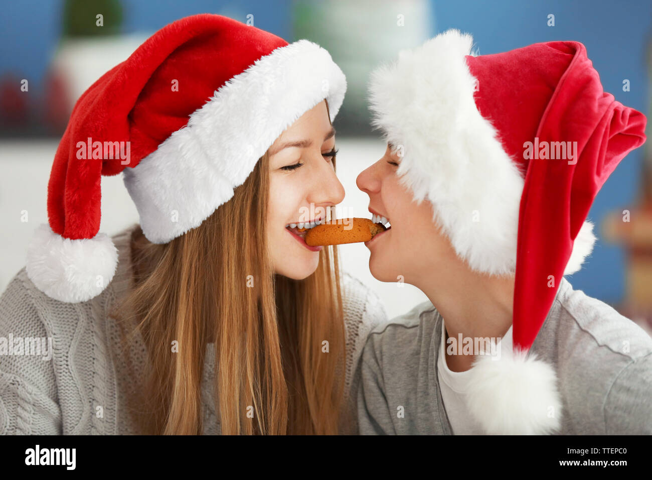 Happy children eat cookie together, close up Stock Photo - Alamy