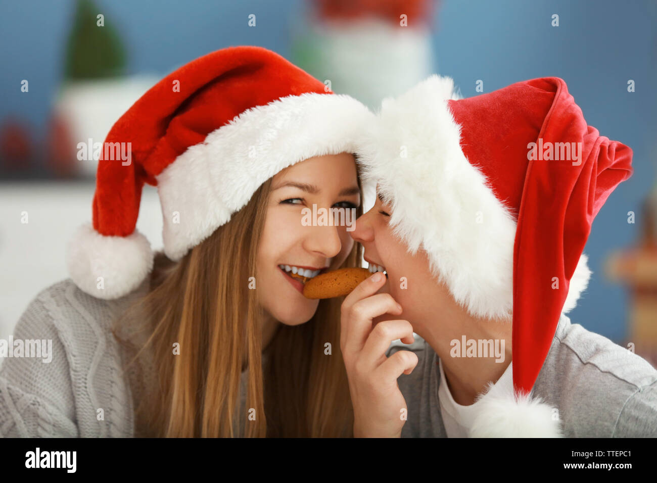 Happy children eat cookie together, close up Stock Photo - Alamy