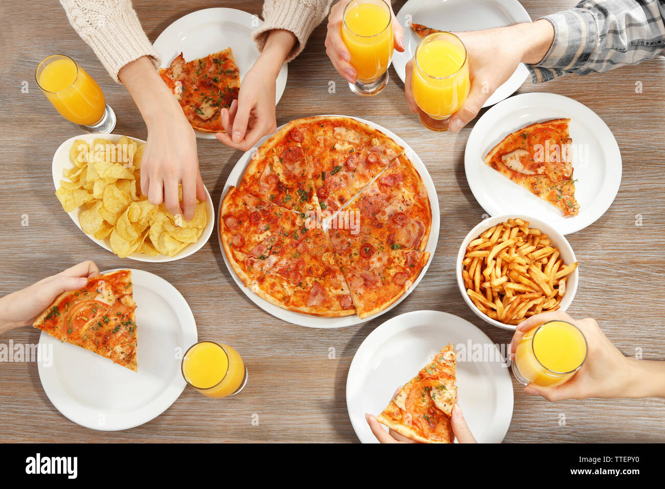 Friendly party with hot pizza and drinks, close up Stock Photo - Alamy