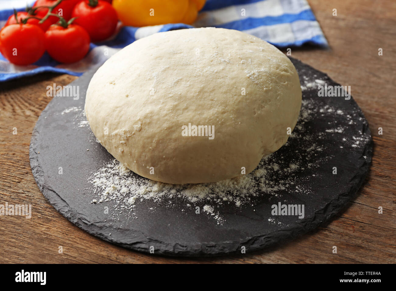 Fresh prepared dough on a black wooden board, close up Stock Photo - Alamy