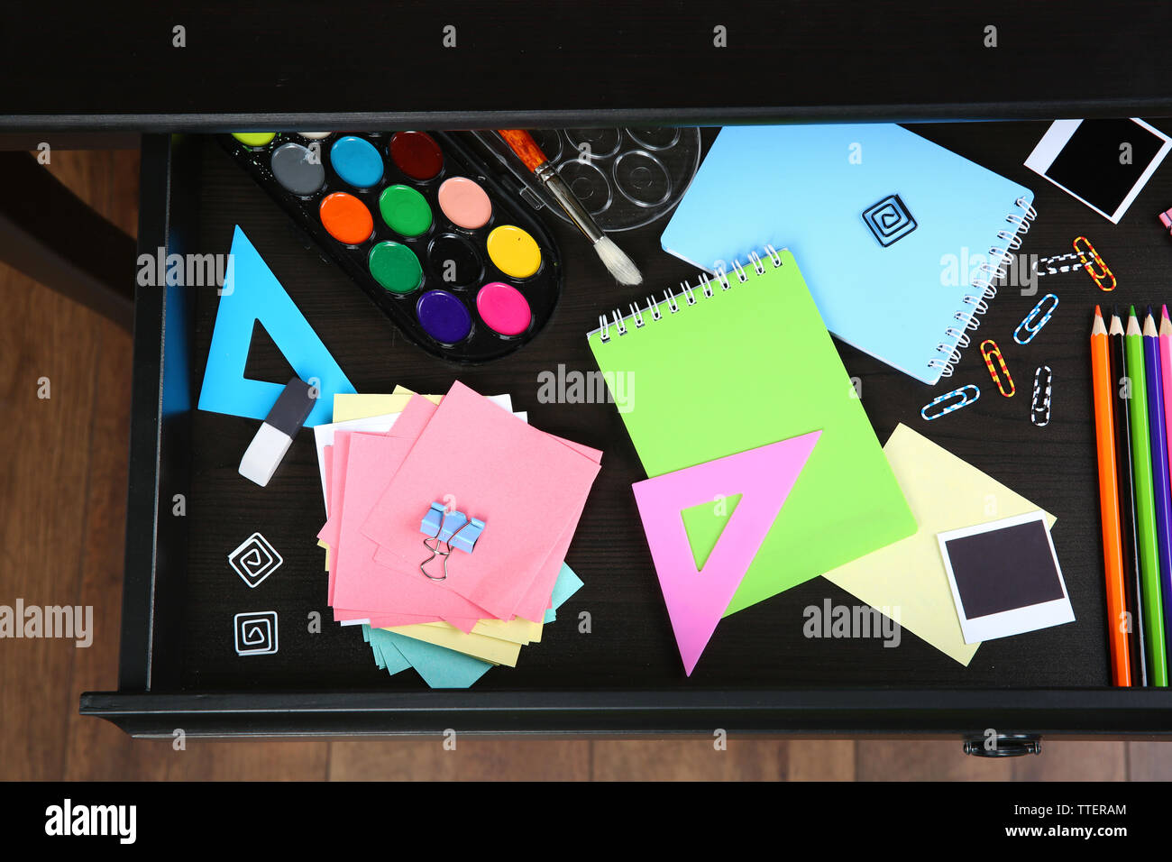Stationery in open desk drawer, top view Stock Photo - Alamy