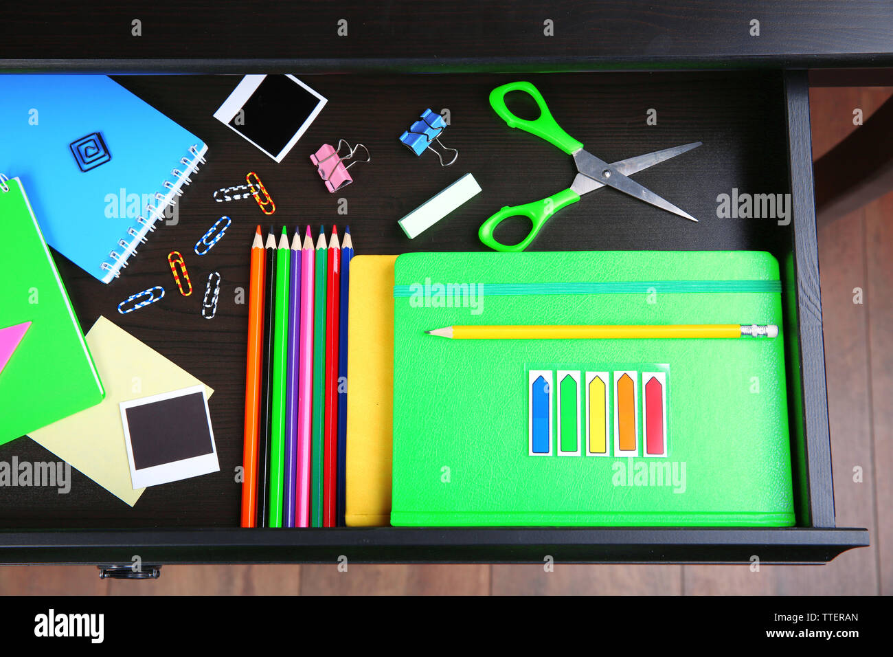 Stationery in open desk drawer, top view Stock Photo - Alamy