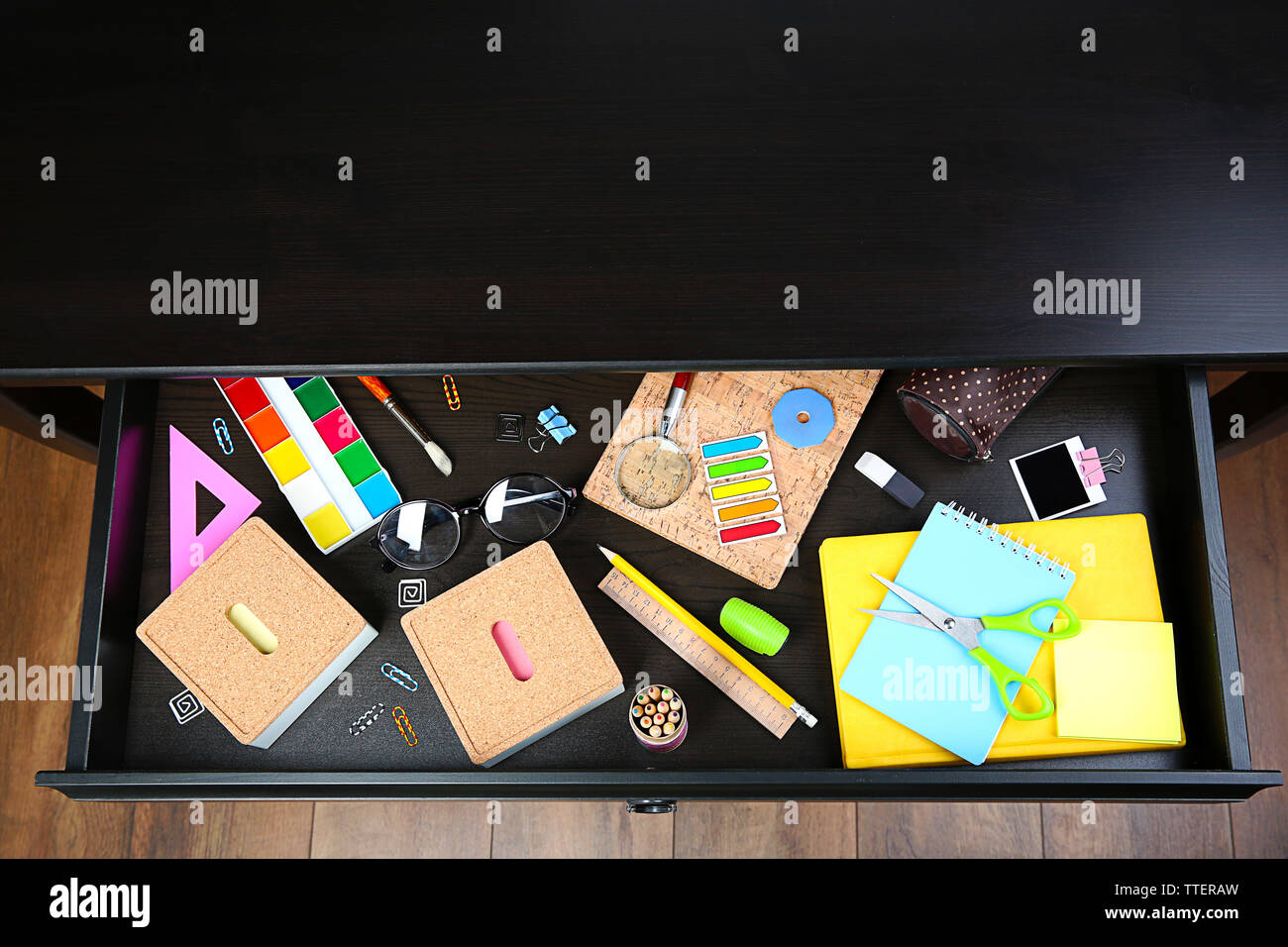 Stationery in open desk drawer, top view Stock Photo - Alamy