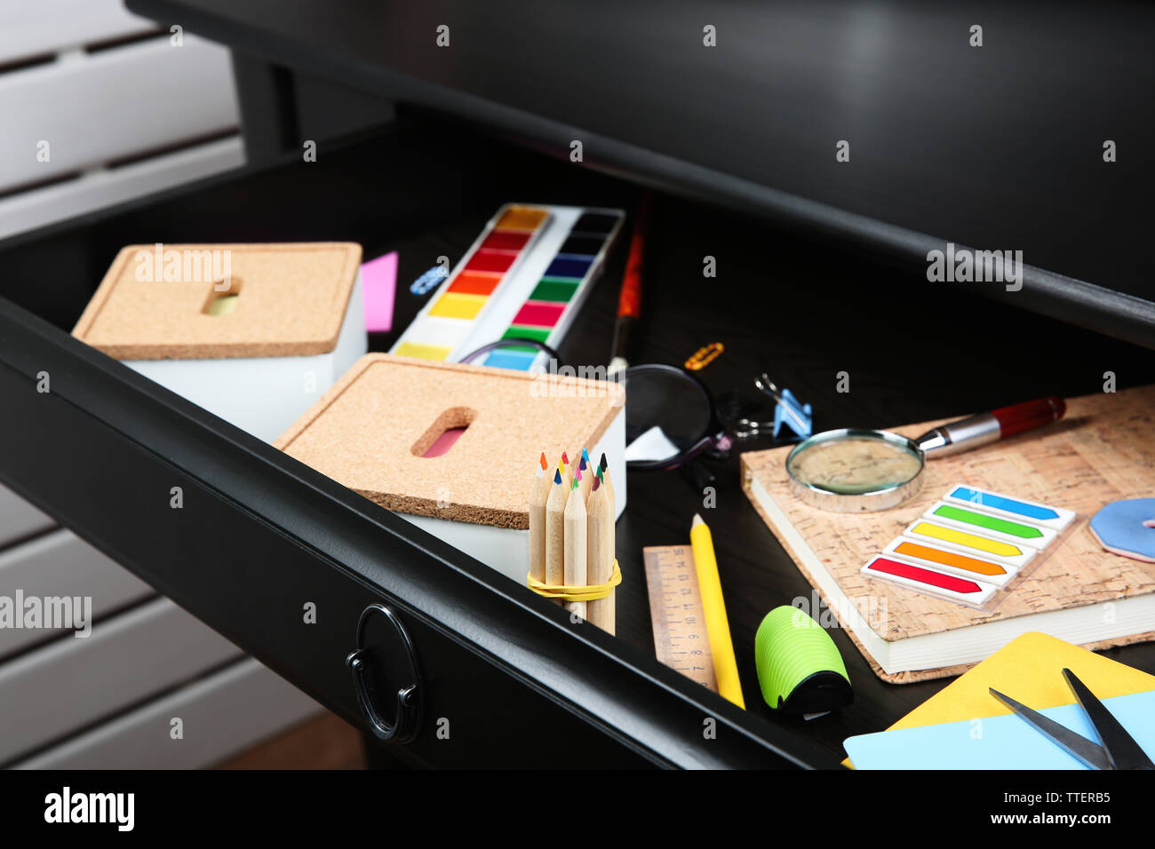 Stationery in open desk drawer closeup Stock Photo - Alamy