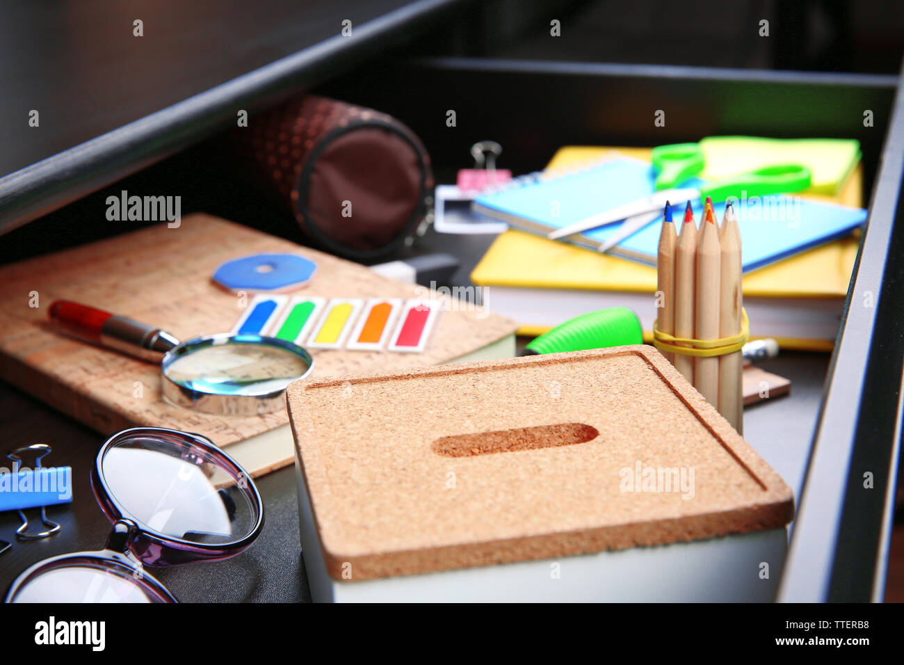 Stationery in open desk drawer closeup Stock Photo - Alamy