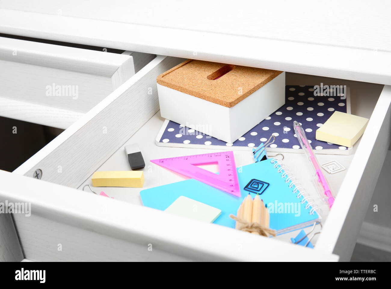 Stationery in open desk drawer closeup Stock Photo - Alamy