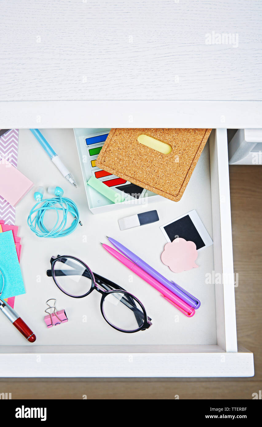 Stationery in open desk drawer, top view Stock Photo - Alamy