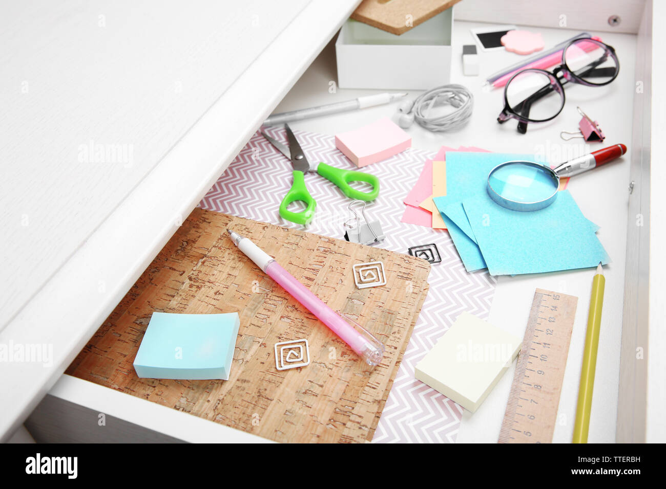 Stationery in open desk drawer closeup Stock Photo - Alamy