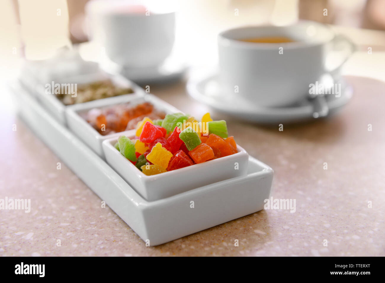 Set of candies and tea on table close up Stock Photo - Alamy