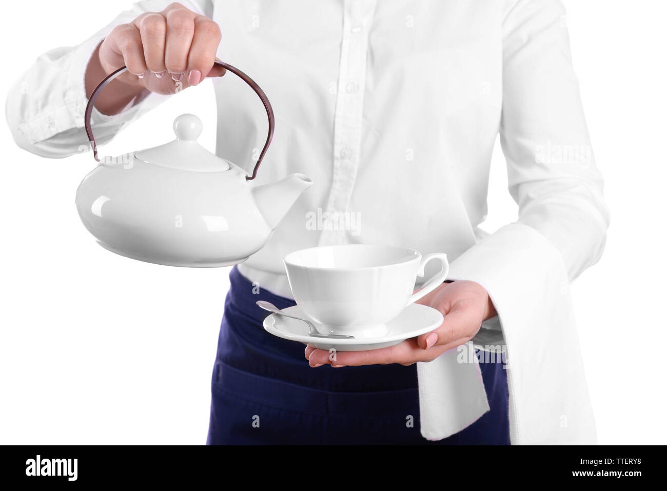 Waiter pouring tea into cup on white background Stock Photo - Alamy