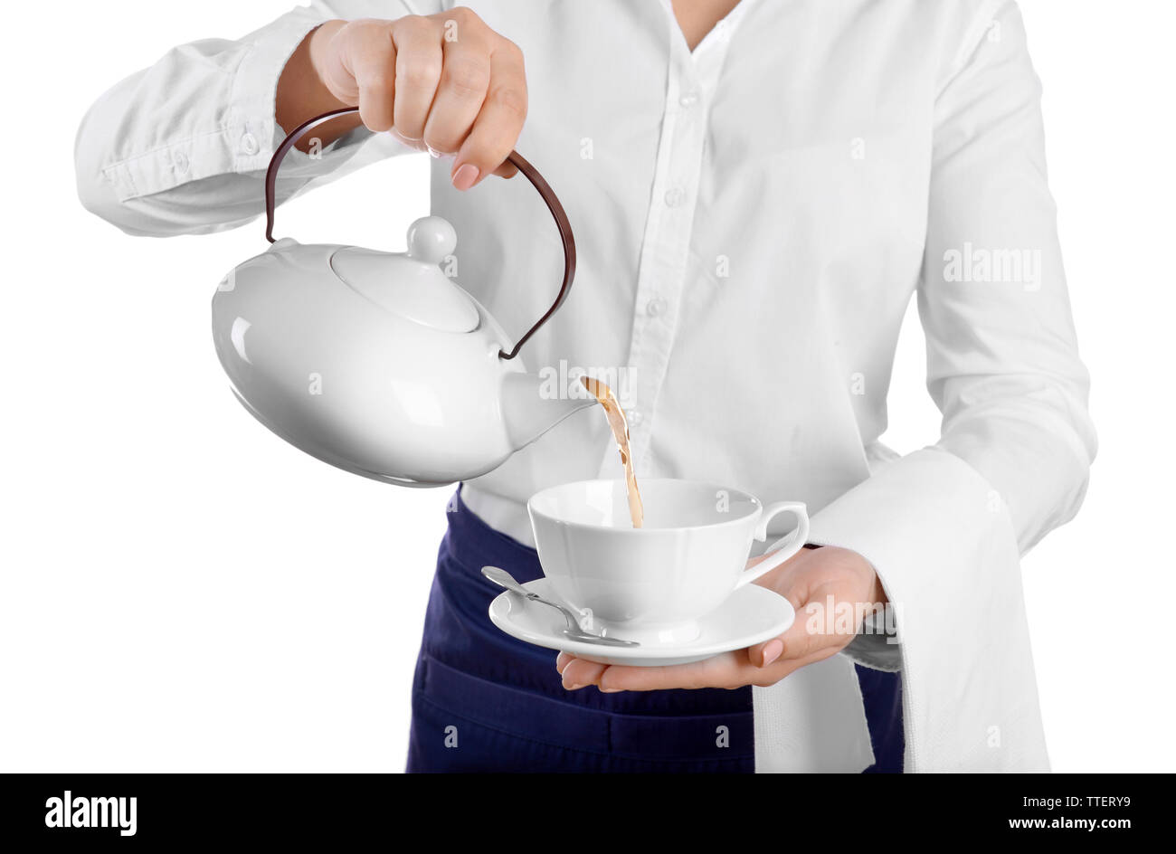 Waiter pouring tea into cup on white background Stock Photo - Alamy