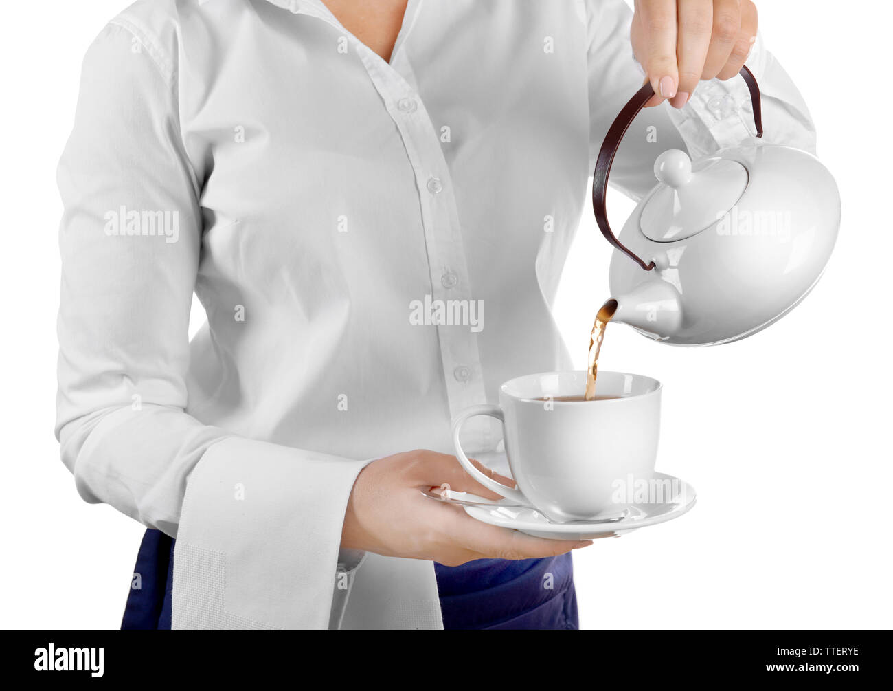 Waiter pouring tea into cup on white background Stock Photo - Alamy