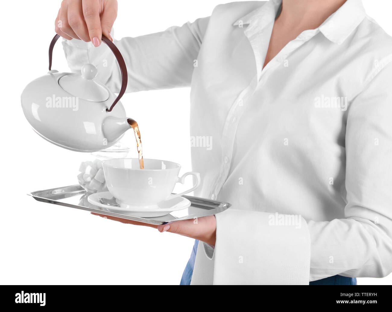 Waiter pouring tea into cup on white background Stock Photo - Alamy