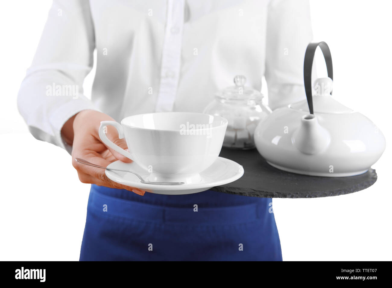 Waiter holding tray with cup and teapot on white background Stock Photo ...
