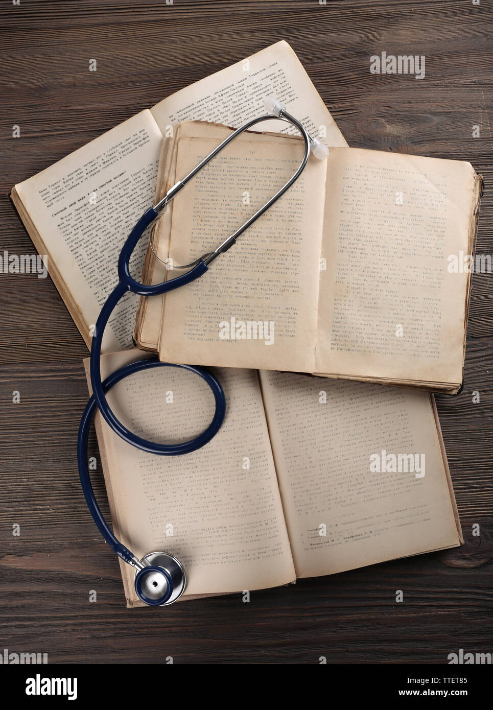 Book and stethoscope on wooden table, top view Stock Photo - Alamy