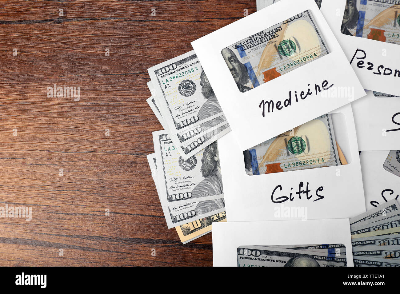 Distribution of money, financial planning, dollars in envelopes, on ...