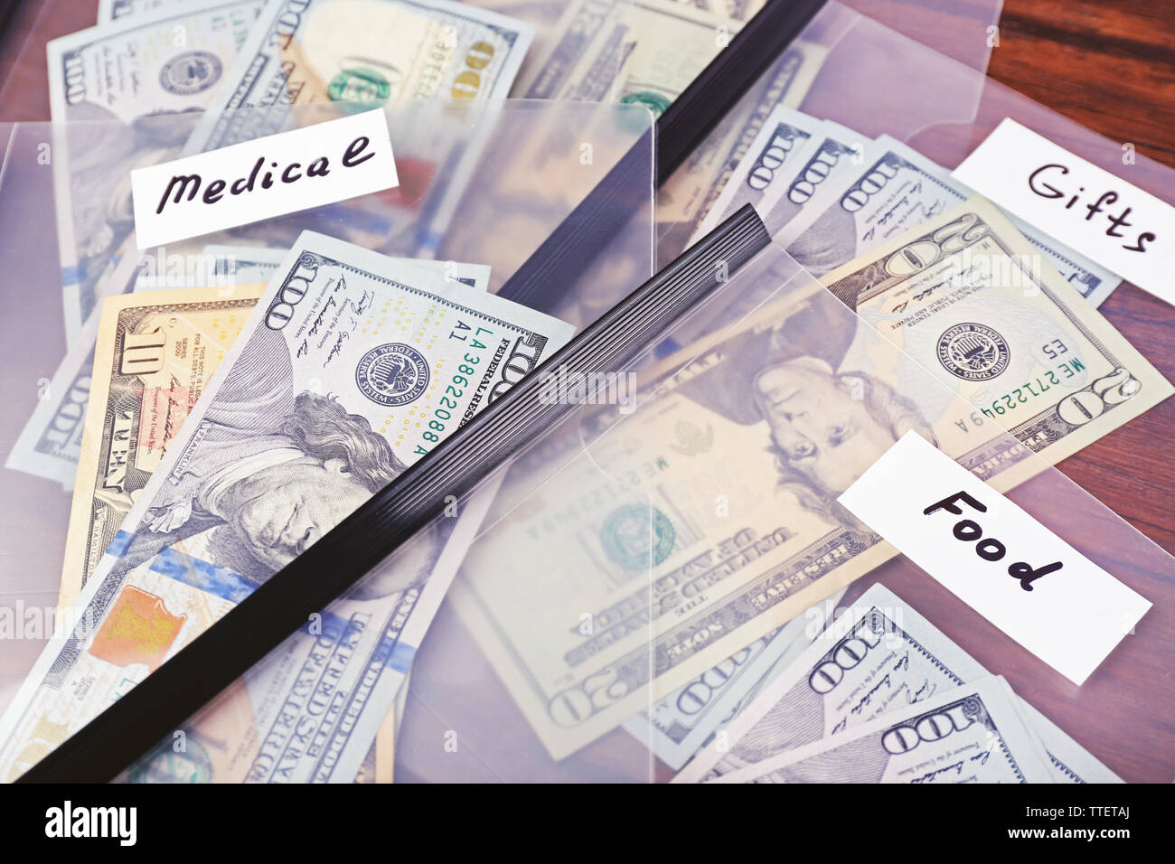 Distribution of money, financial planning, dollars in envelopes, on ...
