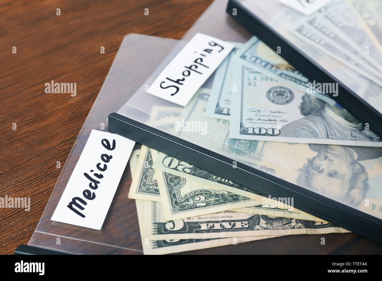 Distribution of money, financial planning, dollars in envelopes, on ...