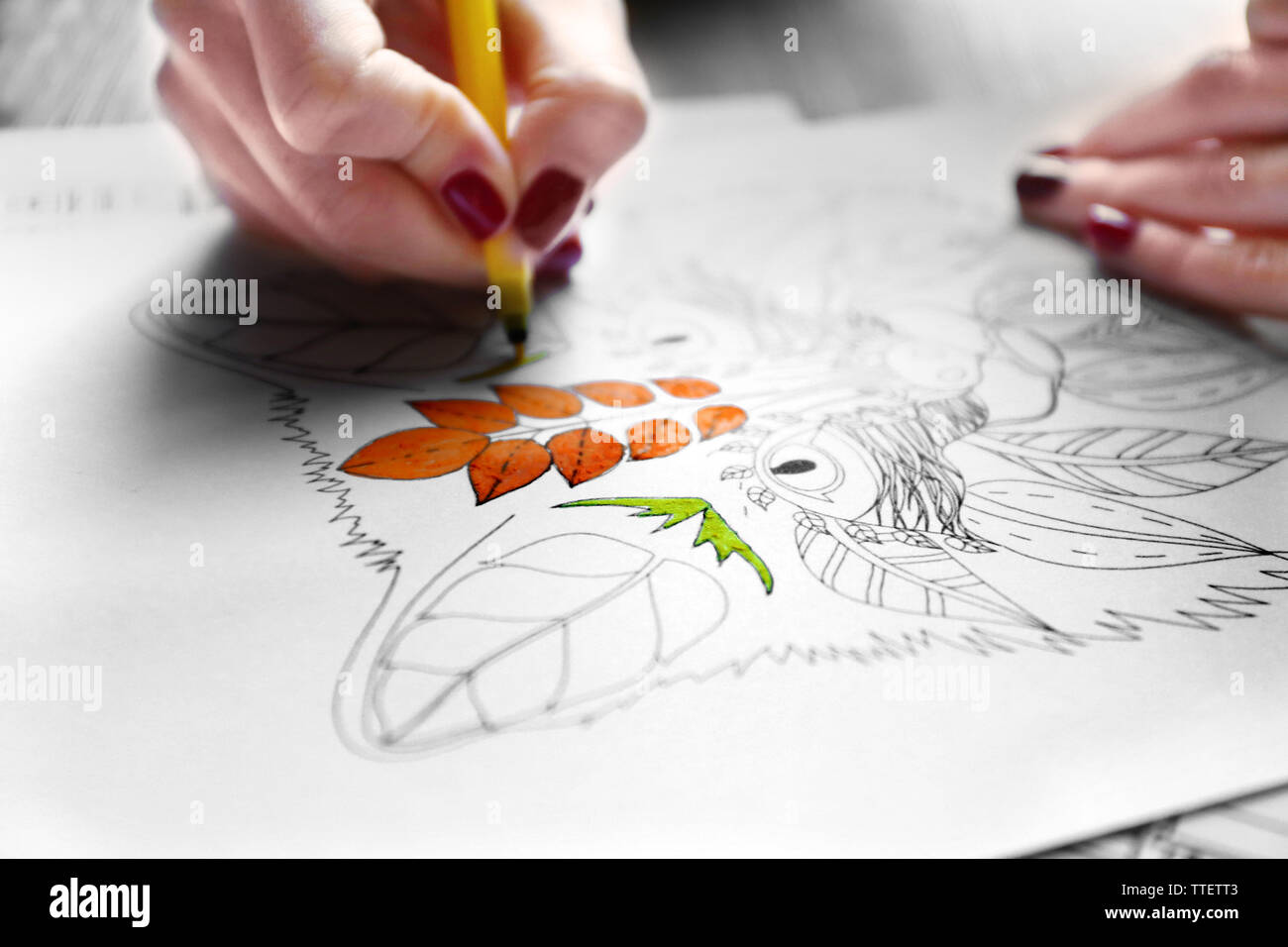 Female hand painting anti stress colouring with yellow felt pen Stock ...