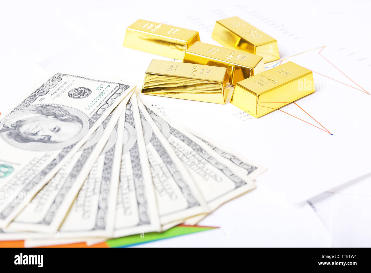Gold bars with dollar banknotes on paper background Stock Photo - Alamy